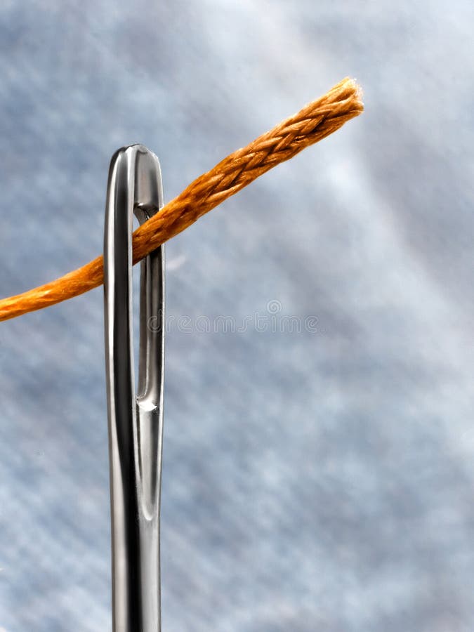 Photo of a Needle and a Thread Threaded through the Eye of a Needle ...