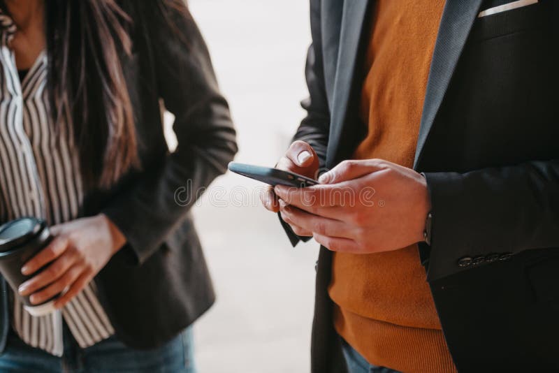 Macro Photo of Young People Using the Phone during a Break from Work ...