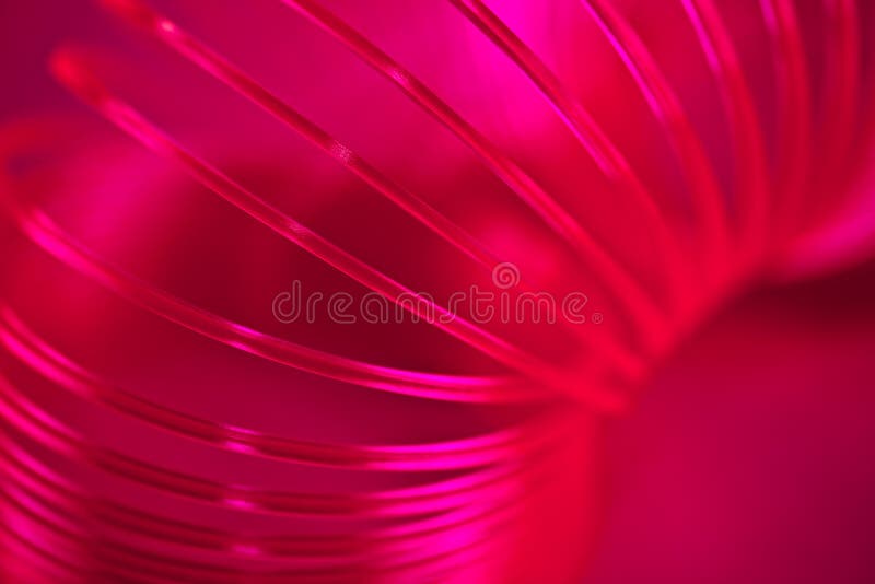 Macro plastic pink slinky editorial photography. Image of bright - 38616962