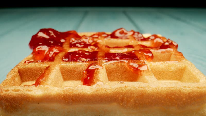MACRO: Raspberry Jam is Spread with a Knife on a Waffle on Wooden Table ...