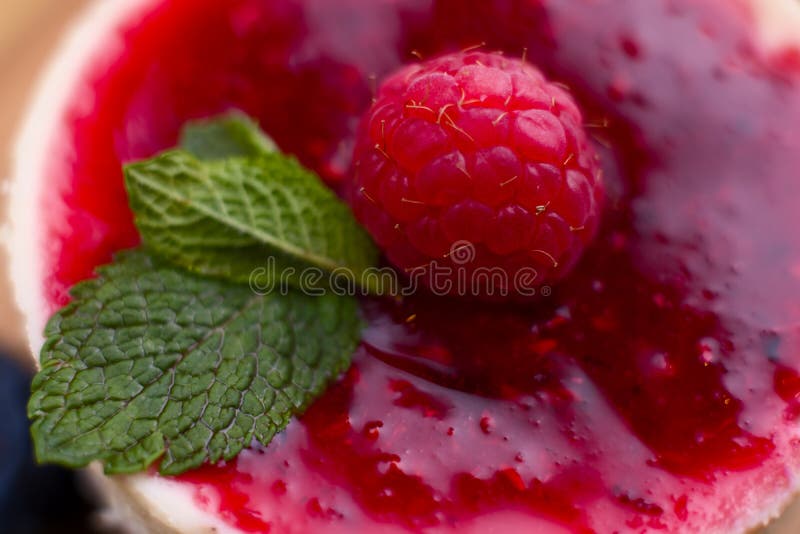 Macro of Red Raspberry Cheesecake Topping with Mint Leaves Decoration ...