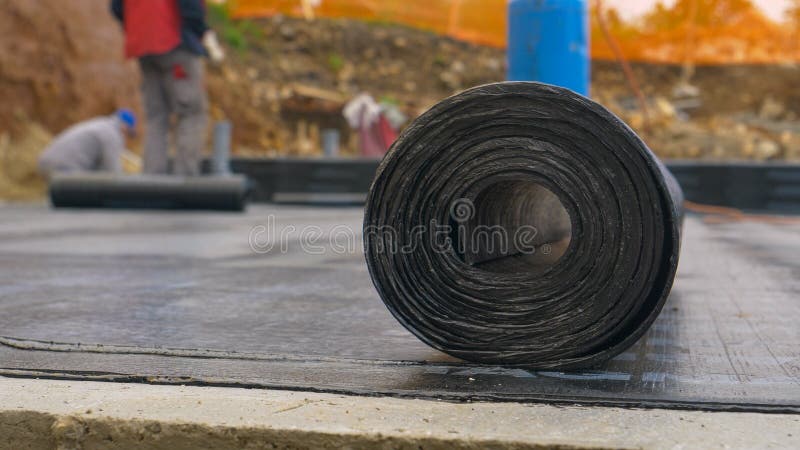 MACRO: Roll of Tar Lies on the Ground As Contractors Work in the ...