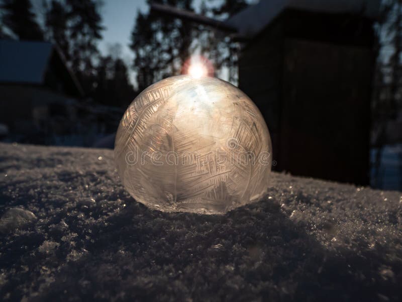 Round, Frozen Soap Bubble Forming Beautiful Leaf and Tree Like Pattern ...