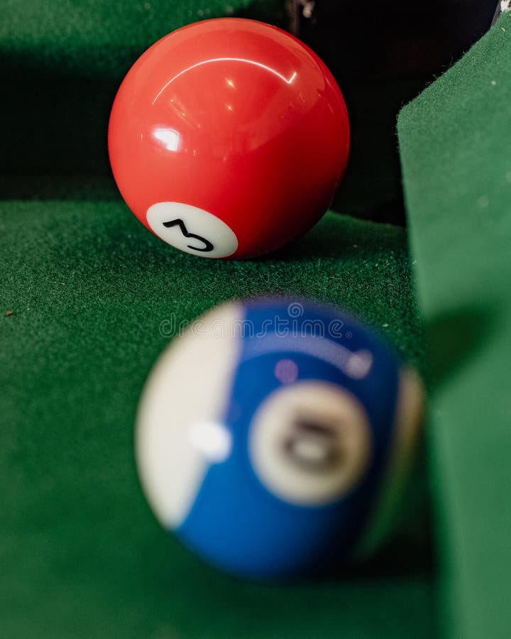 Macro Shot Of A Billiards Setup Focusing On The Red And Blue Striped Pool Balls Against The