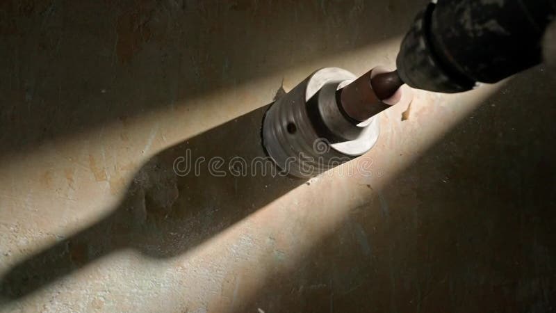 Drilling a Round Hole for Socket on Gray Concrete Wall. Round Nozzle ...