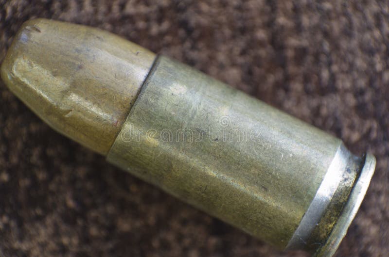 Macro Shot of a 9mm Bullet Isolated on a Brown Surface Stock Image ...