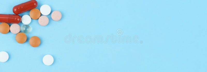 Assorted Pharmaceutical Medicine Pills, Tablets and Capsules Over Blue ...