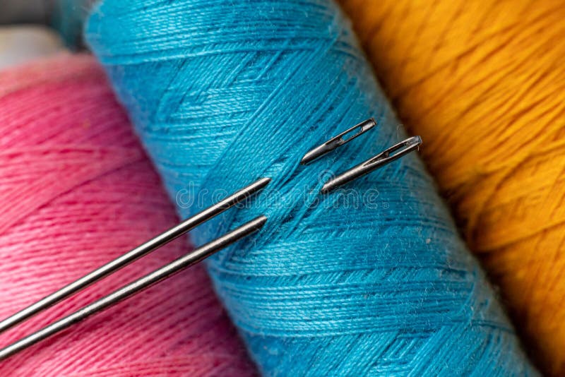 Macro Shot of Needle Inserted in the Color Thread Rolls Stock Photo ...