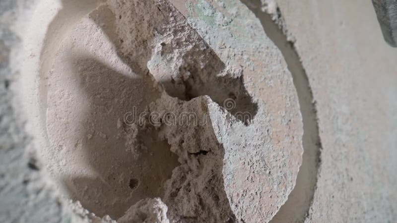Macro Shot of a Process Gouging Round Hole in Plaster Wall for Socket ...