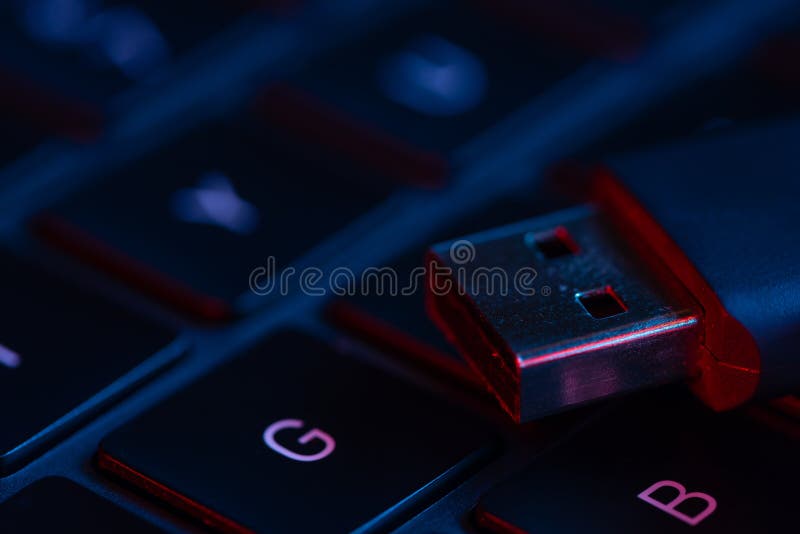Macro Shot of USB Flash Drive on a Laptop Keyboard with Neon Lights ...