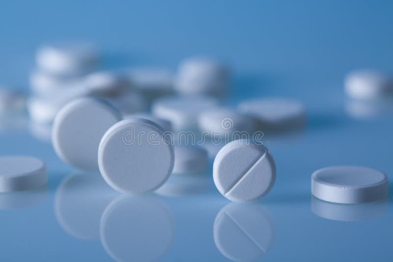 Macro Shot of White Medical Pills on Bright Blue Background Stock Photo ...