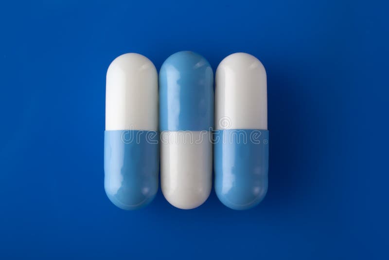 Blue and White Pills on Blue Stock Photo - Image of hope, medication ...
