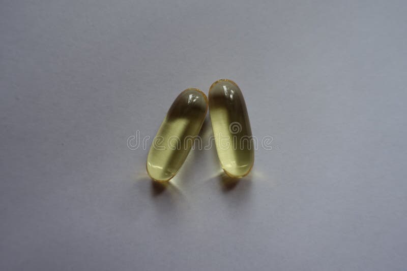 Macro of 2 Capsules of Fish Oil Stock Photo - Image of nutritional ...