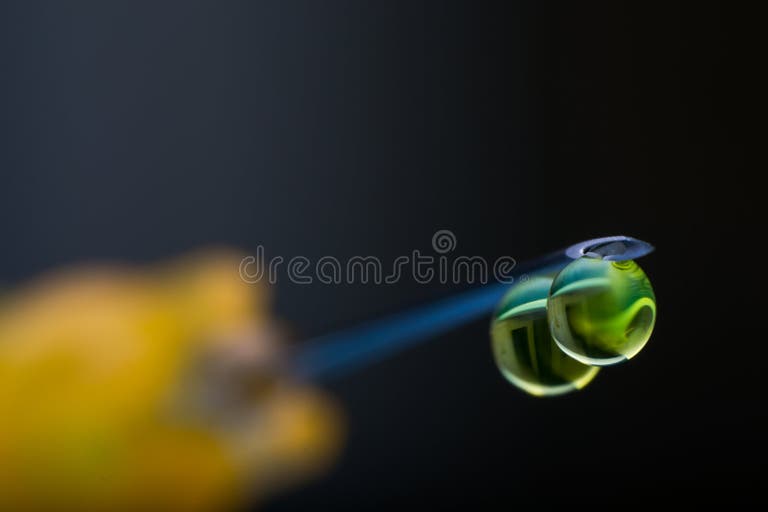 Macro View of a Hypodermic Needle with Two Drops of Drug Solution on ...