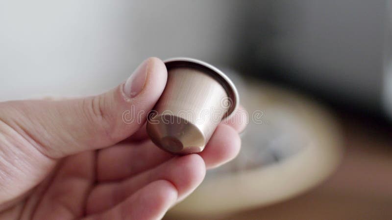 Man`s Hand Holds Small Brown Capsule of Automatic Coffee Machine. Stock ...