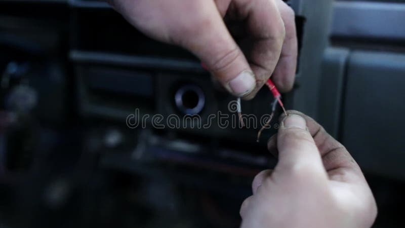 Macro View of Man`s Hands Trying To Connect and Tie Two Bare Red Cables ...