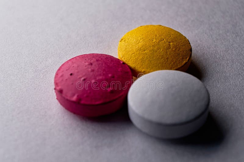 Macro of White Red Yellow Medical Pill Tablet on White Stock Photo ...