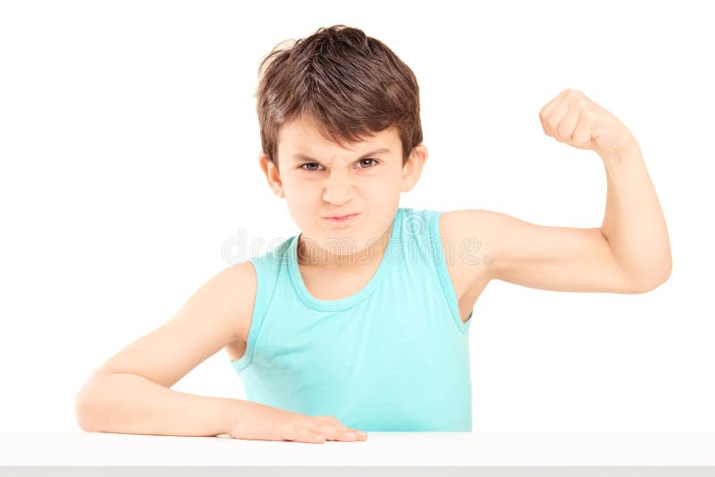 A Mad Child Showing His Muscles Seated on a Table Stock Photo - Image ...