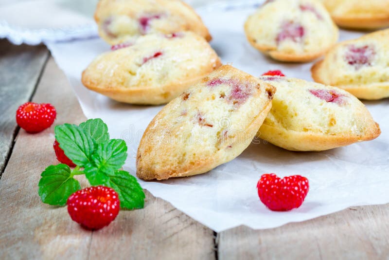 Madeleines Cookie with Raspberry on Parchment Paper Stock Photo - Image ...