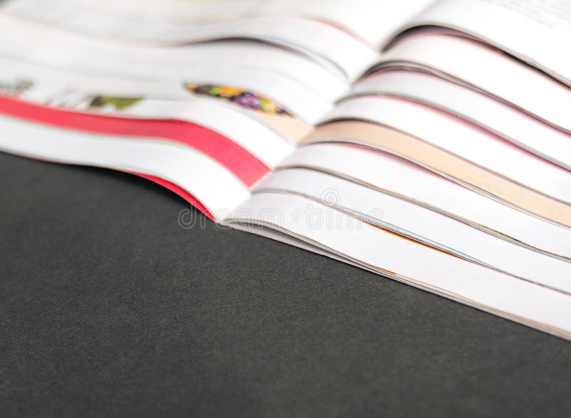 Magazines open on table stock image. Image of paper - 273930197
