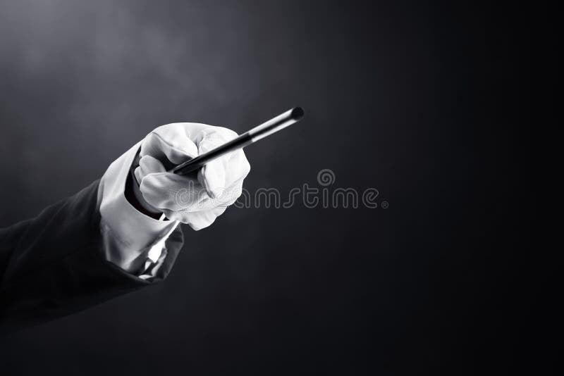 Magician Hand Holding Magic Wand on Dark Backgrounds Stock Photo ...