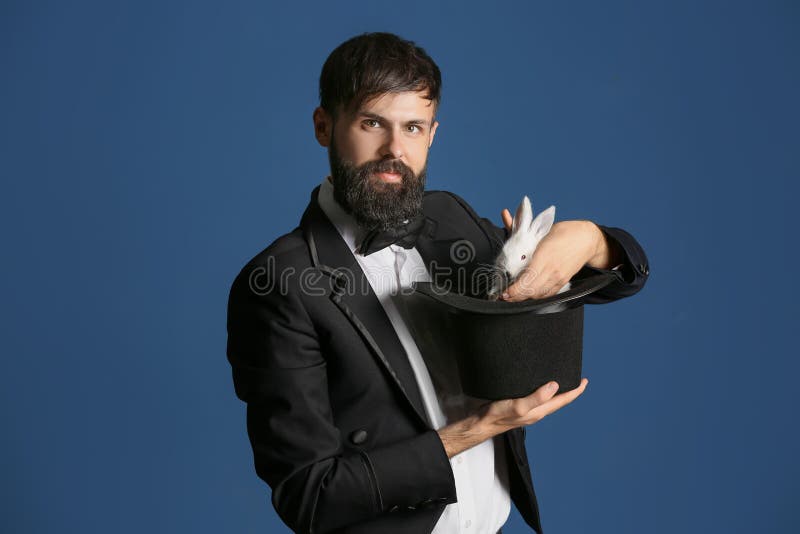 Magician Holding Hat with Rabbit on Color Background Stock Image ...