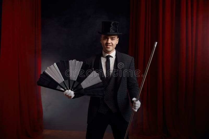Magician Performing Miracle Trick on Stage Using Fan and Cane Stock ...