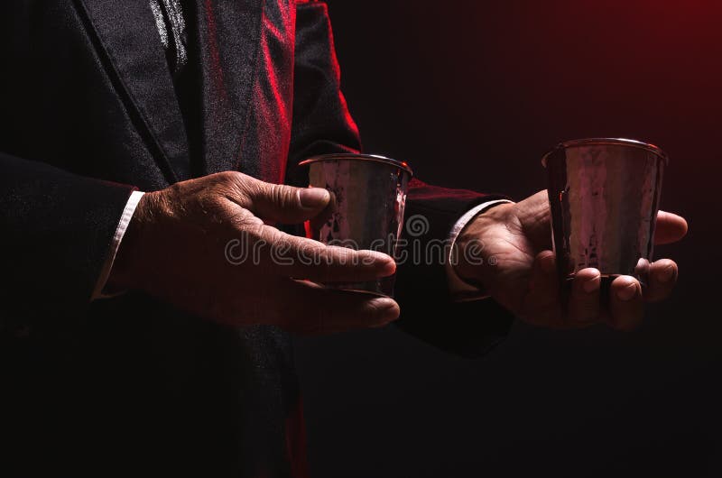 Magician Shows Trick with a Metal Cup. Manipulation with Props. Stock ...