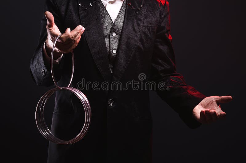 Magician Shows Trick with Metal Rings. Manipulation with Props. Stock ...