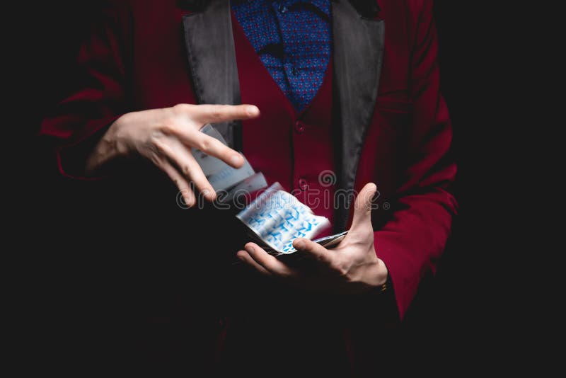 Magician Shows Trick with Playing Cards on Dark Background, Copy Space ...