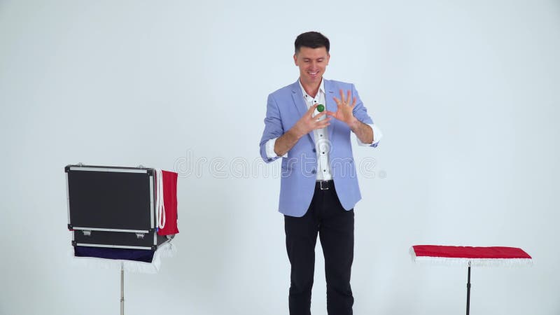 Magician in a Suit Shows a Trick with Balls on a White Background Stock ...