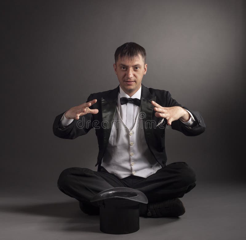 Magician holding magic hat stock photo. Image of magic - 60771436