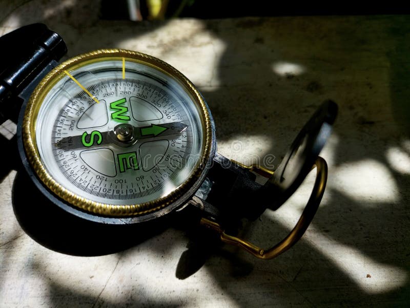 Magnetic Compass on Textured Shadows Background Stock Image - Image of ...