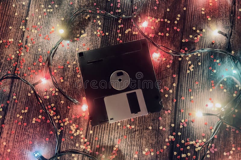 Used Floppy Diskette with Multi Colored New Year S Lights on Wooden ...