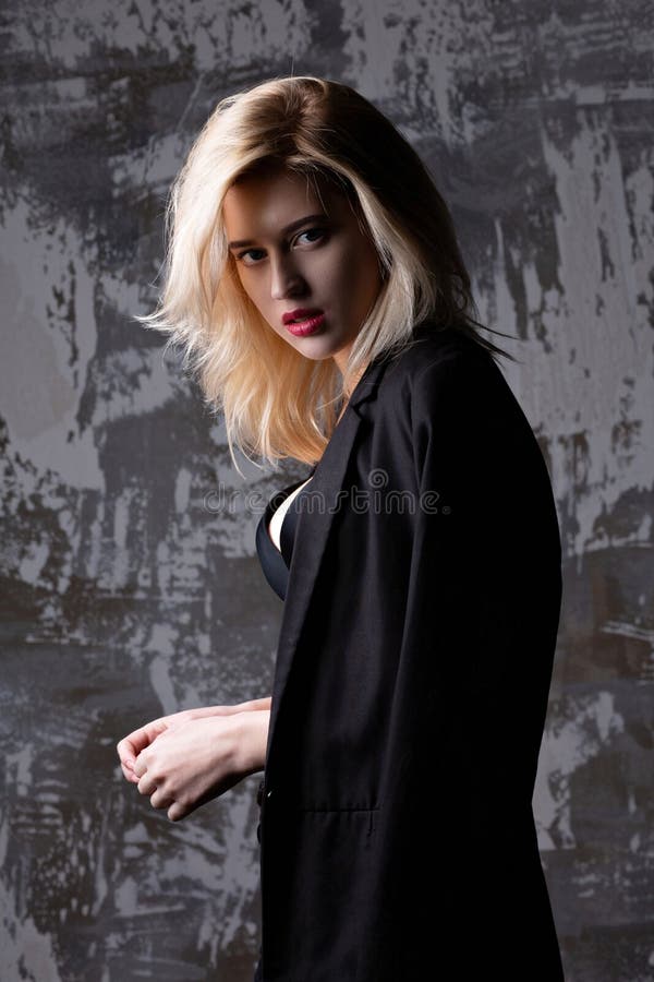 Magnificent Blonde Model Wearing Jacket and Bra Posing at Studio with ...