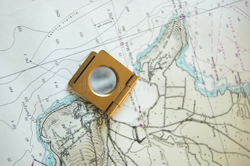 A magnified view of map, An old magnifier lens lying on a map