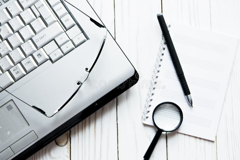 Magnifier, Glasses on a Laptop, Notebook and Pen Stock Image - Image of ...