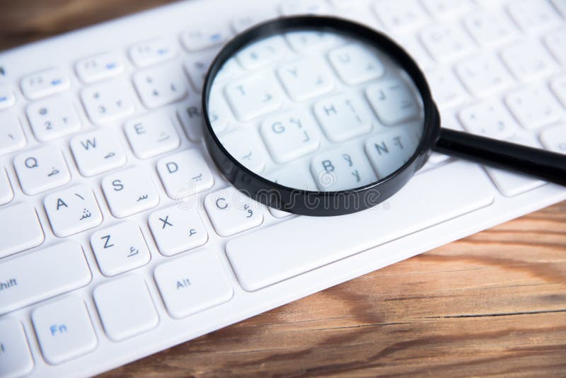 Magnifier on keyboard stock photo. Image of detective - 193248618