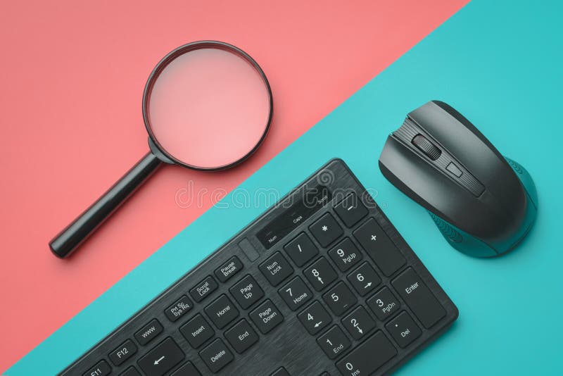 Magnifier and Keyboard with a Computer Mouse on a Colored Background As ...