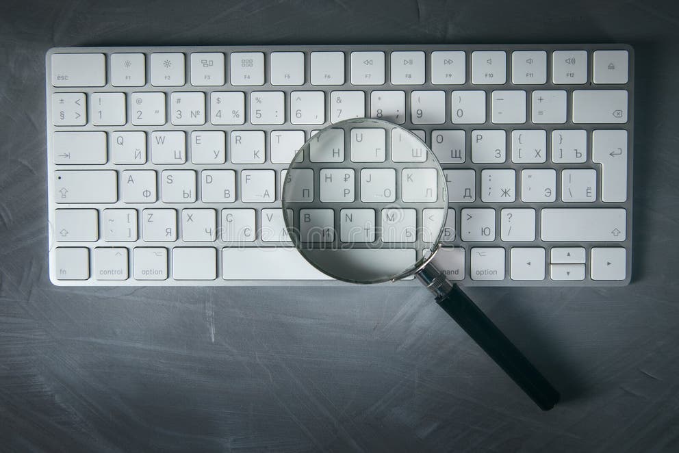 Magnifier on the keyboard stock photo. Image of information - 255828740