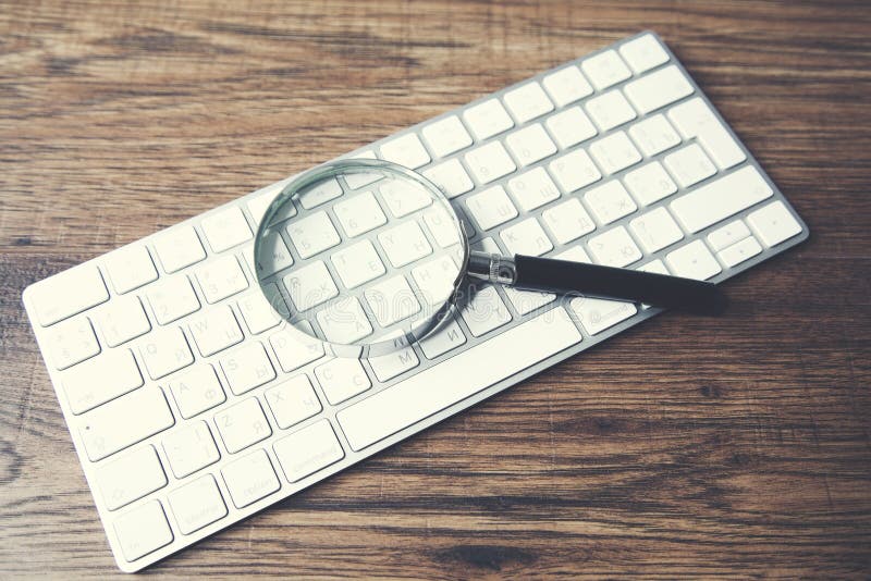 Magnifier on Keyboard on Wooden Table Stock Image - Image of laptop ...