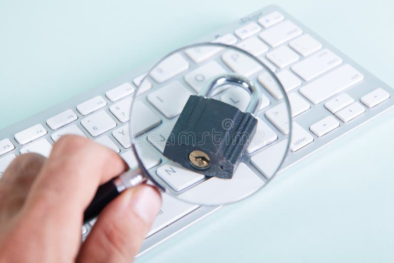 Magnifier Looks at the Lock on the Keyboard. Security Search Concept ...