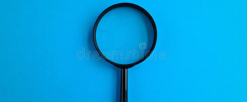 Magnifying Glass on a Blue Background Closeup Stock Image - Image of ...