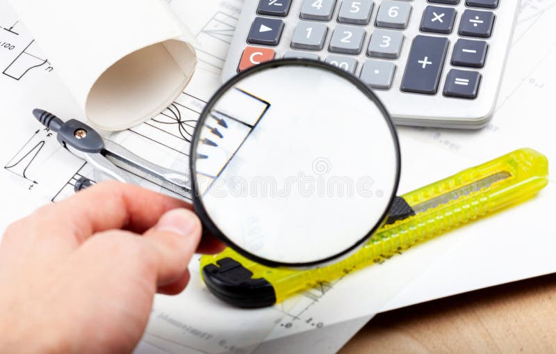 Magnifying Glass on a Bunch of Technical Drawings with Calculator ...