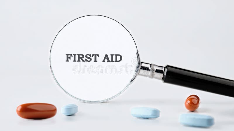 A Magnifying Glass Clearly Highlights the Term First Aid Next To ...