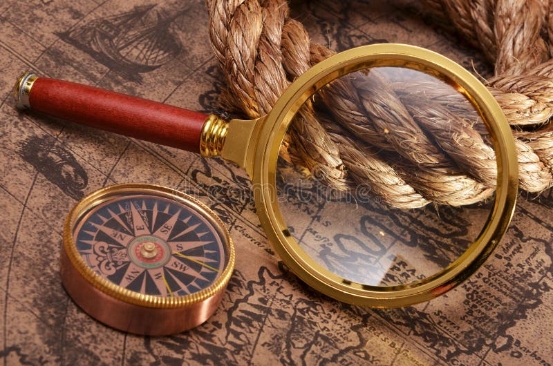 Magnifying Glass and Compass on the Ancient Map Stock Photo - Image of ...