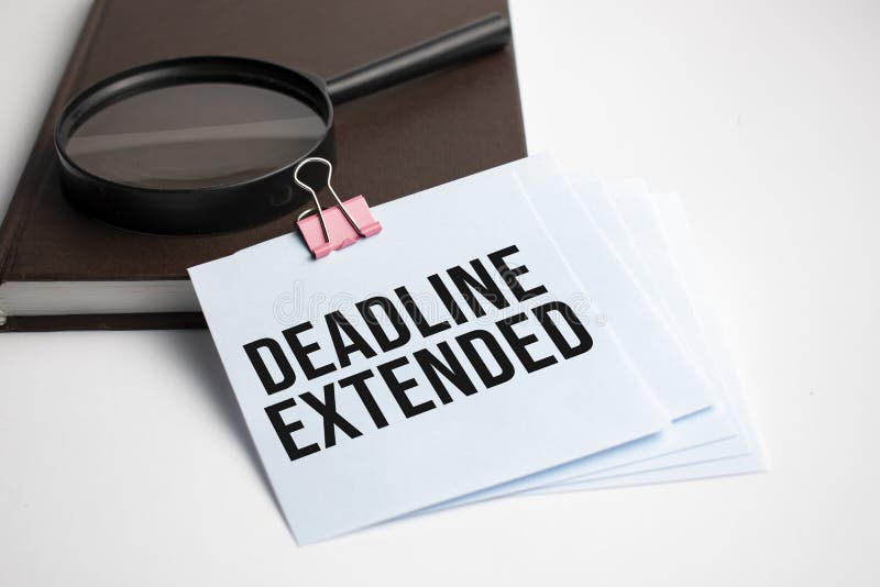 Magnifying Glass with DEADLINE EXTENDED Sign on the Paper Sheet Stock ... Magnifying Glass with DEADLINE EXTENDED Sign on the Paper Sheet Stock ...