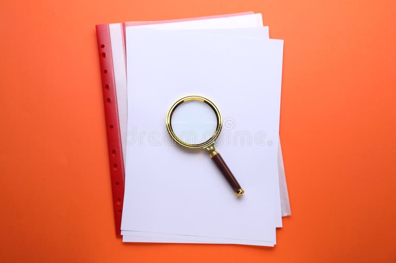 Magnifying Glass and Folder with Paper Sheets on Orange Background, Top ...