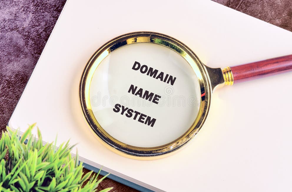 A Magnifying Glass Highlights the Term Domain Name System on a Notebook ...