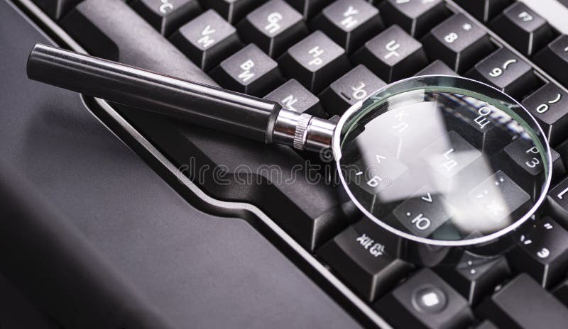 Magnifying Glass on the Keys of a Black Computer Keyboard Stock Photo ...